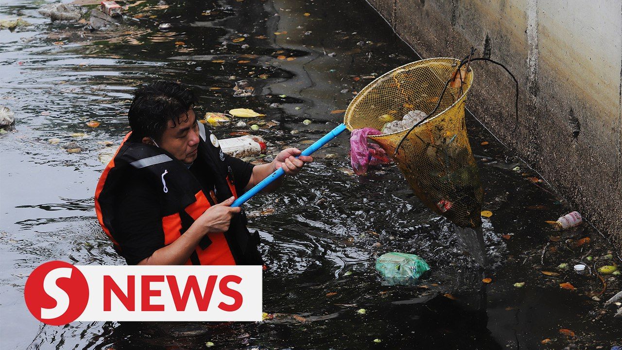 MCA man leaps into garbage-filled drain to drive home message on ...