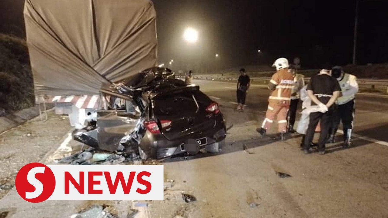 Two killed after car hits stationary trailer on emergency lane ...