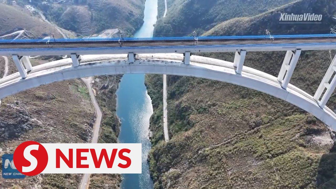 Maintenance workers safeguard railway bridge in Southwest China amid ...