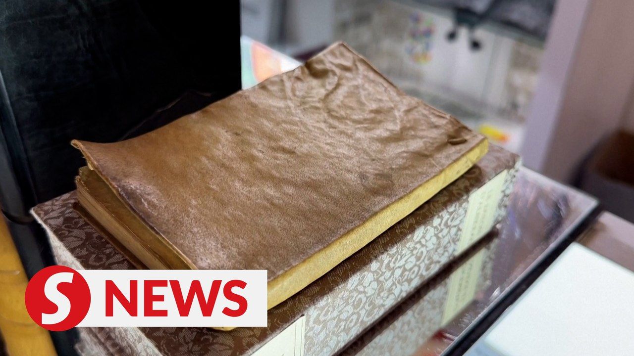 A book bound in human skin is showcased at a New York book fair ...