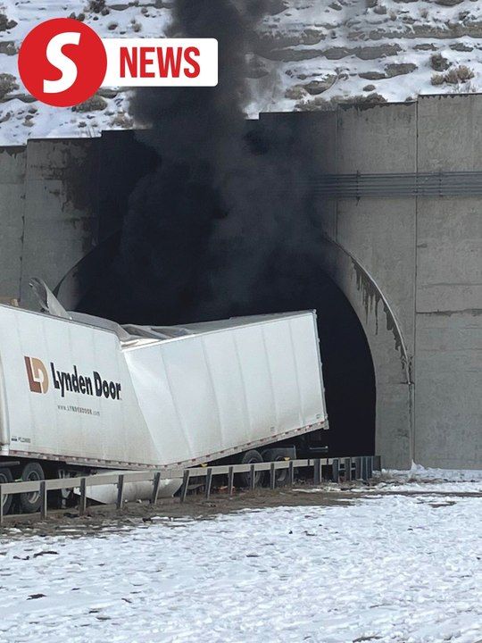 Investigators enter a highway tunnel in Wyoming where a fiery crash ...
