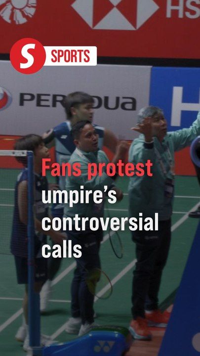 Fans wave handphone torchlight and boo in protest of controversial ...